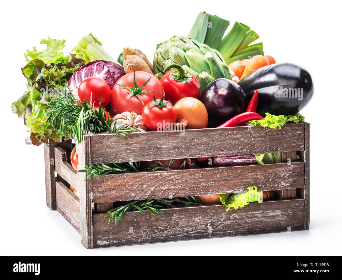 Fresh multi-colored vegetables in wooden crate. White background Stock ...