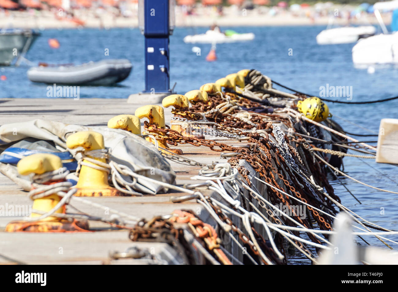 A mooring bollard entwined with a mooring rope. Moored ships at the ...