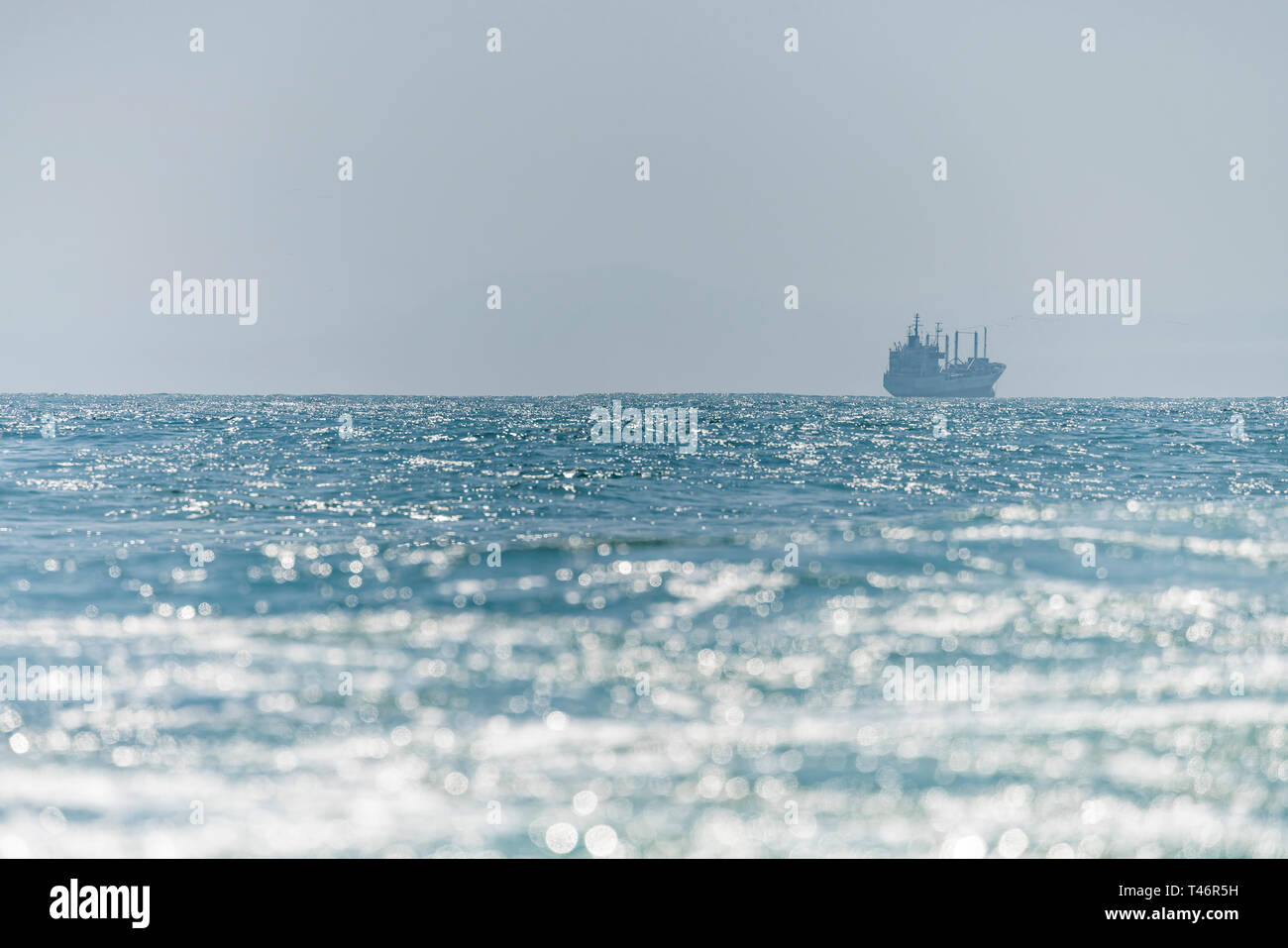 Sea ship sails. Along the shore at sun light Stock Photo - Alamy