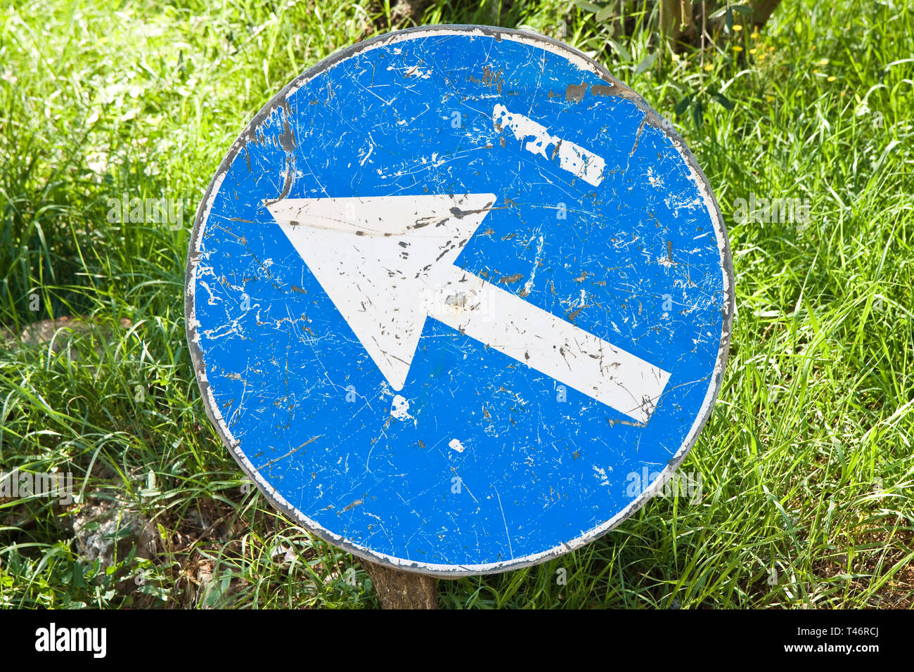 Road blue sign with arrow in the countryside Stock Photo - Alamy