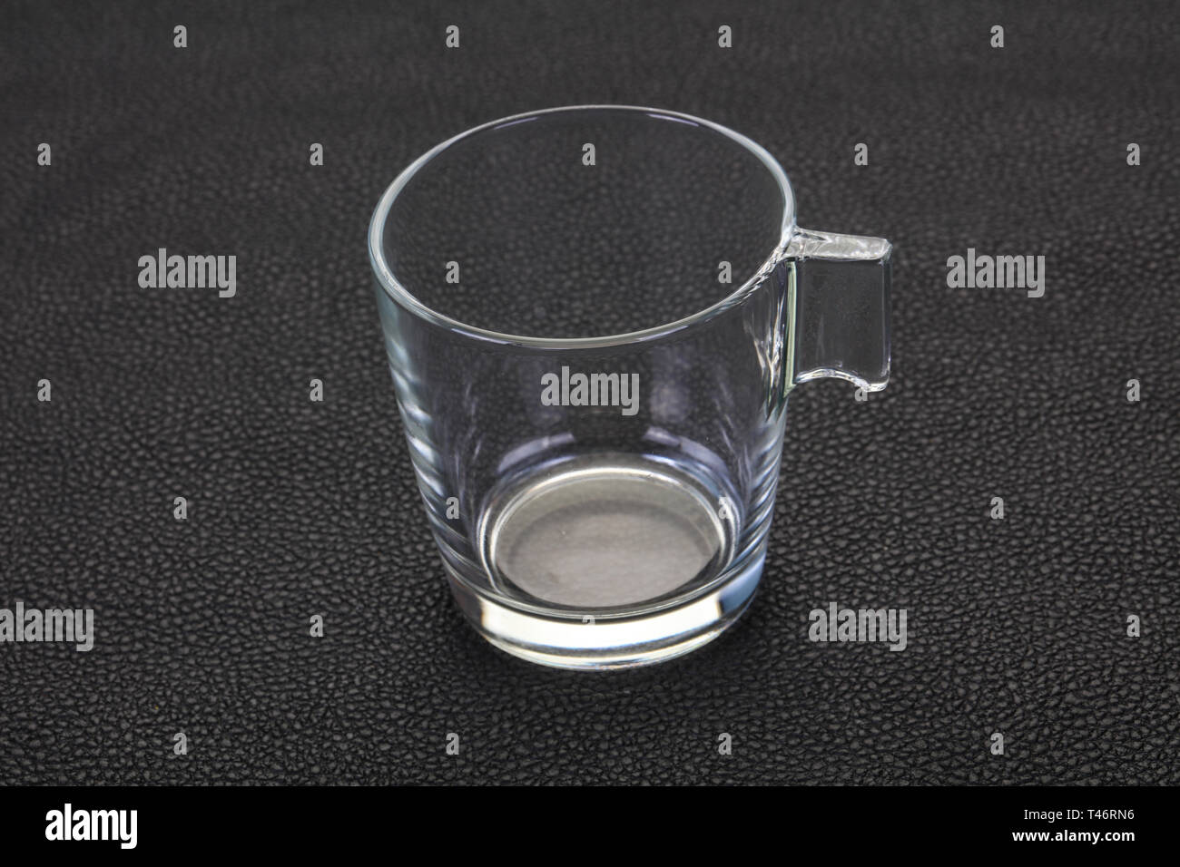 Empty glass cup over black background Stock Photo - Alamy