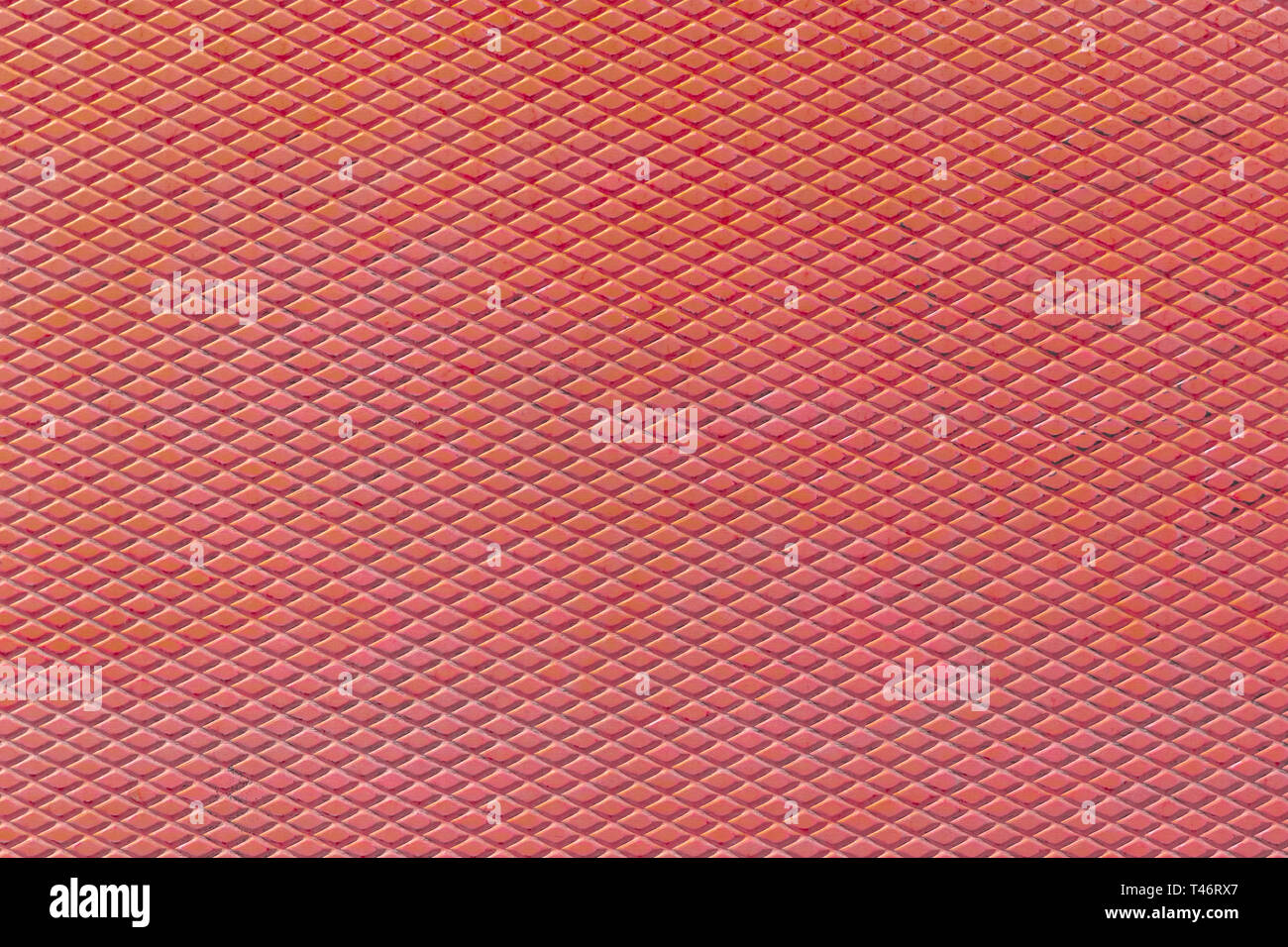 Corrugated steel sheet with rust. Rhombic pattern with an orange tint ...