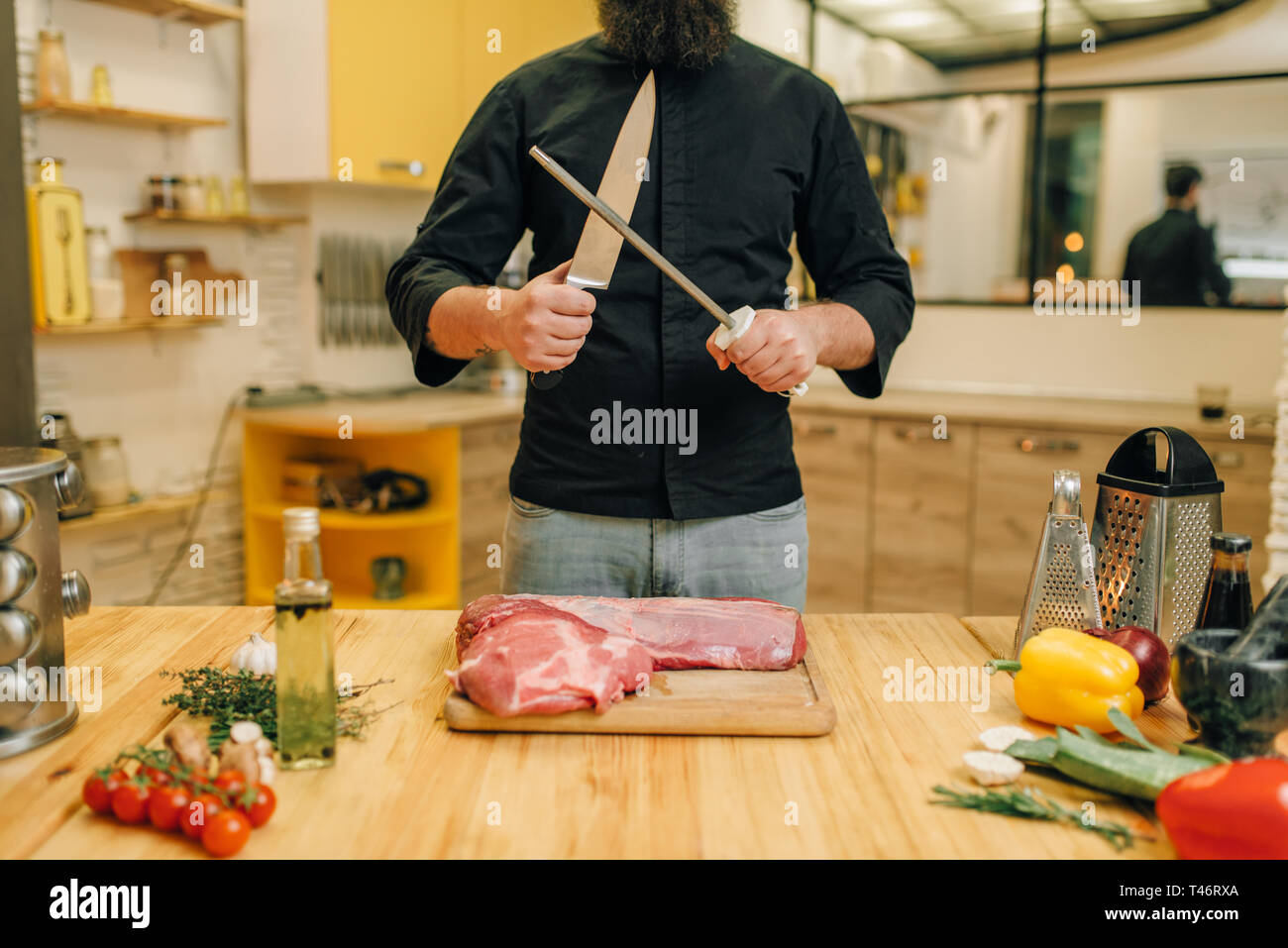 Male person with knife prepares to cut raw meat Stock Photo - Alamy