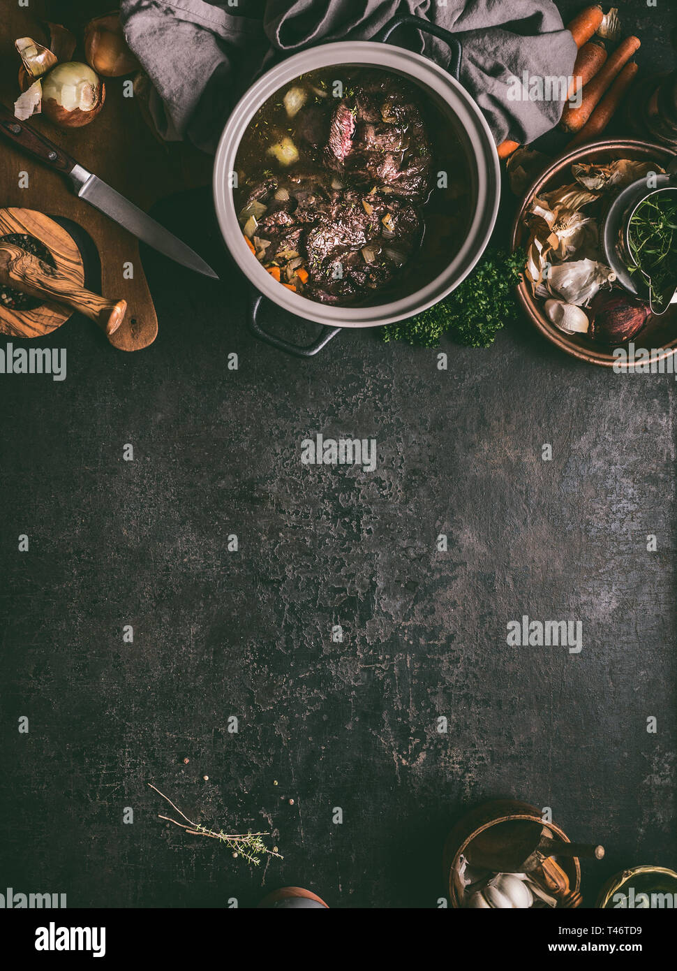 Food background with stewed beef meat in cooking pot on dark table with ...