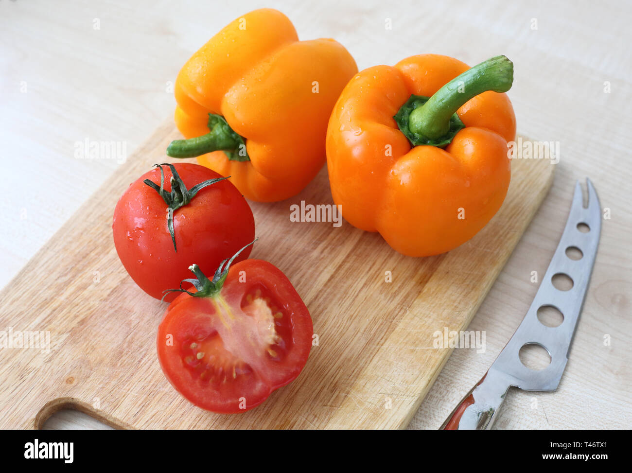 Tomatoes, pepper, knife on the board isolated on white background Stock ...