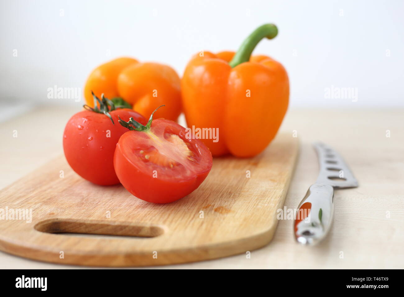 Tomatoes, pepper, knife on the board isolated on white background Stock ...