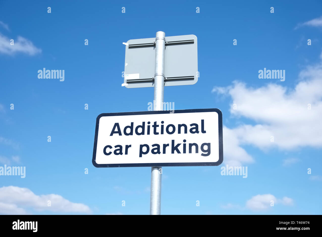 Additional car parking sign against blue sky Stock Photo - Alamy