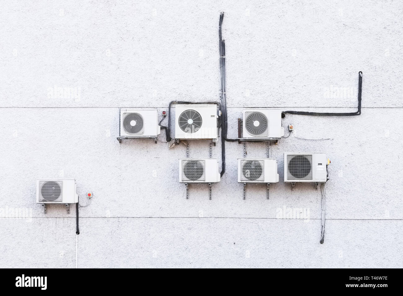 Air conditioning condensers on white wall refrigerant gas pipe Stock ...