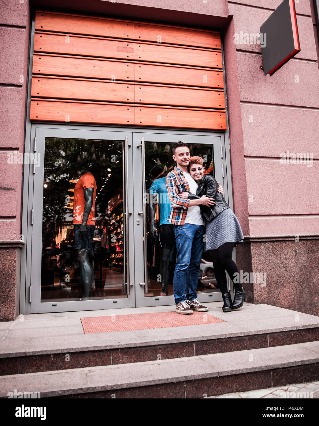 couple in love standing near the shop window. the concept of the ...