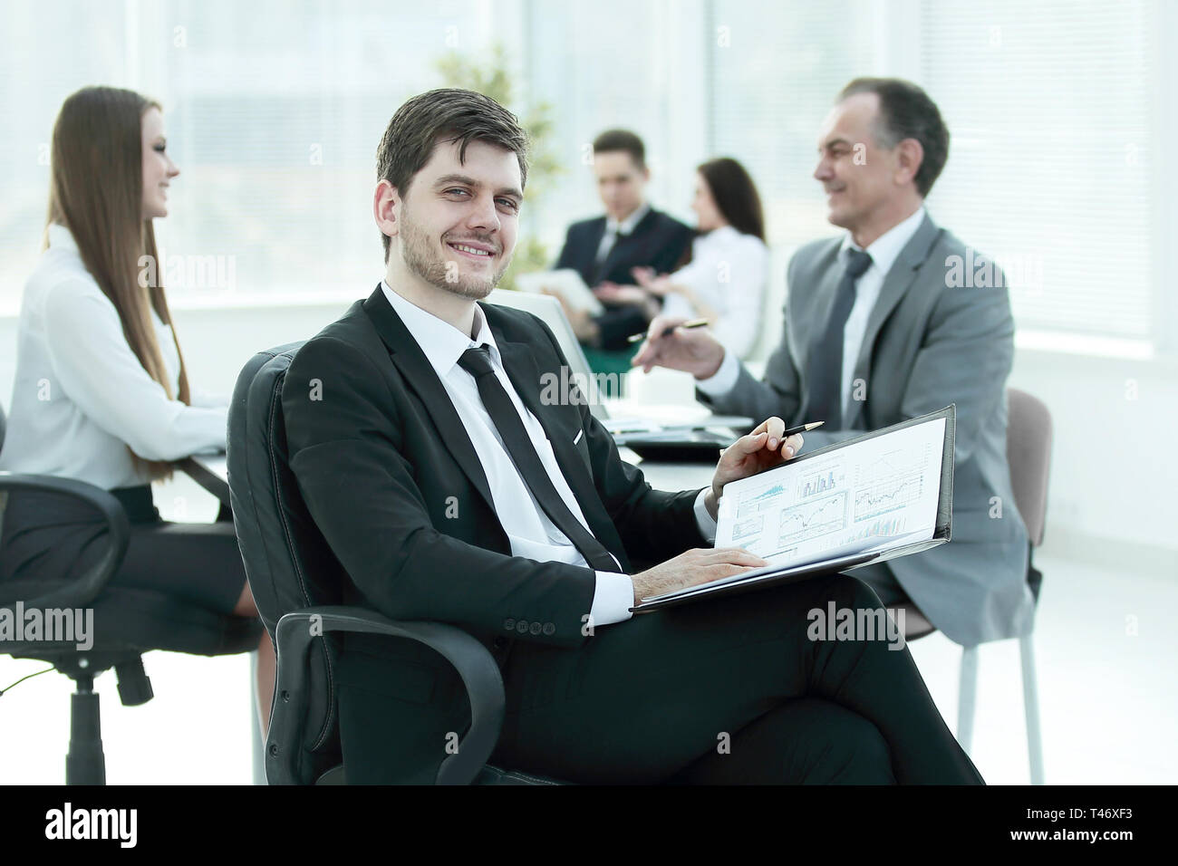 business man at office with his business team working behind.photo with ...