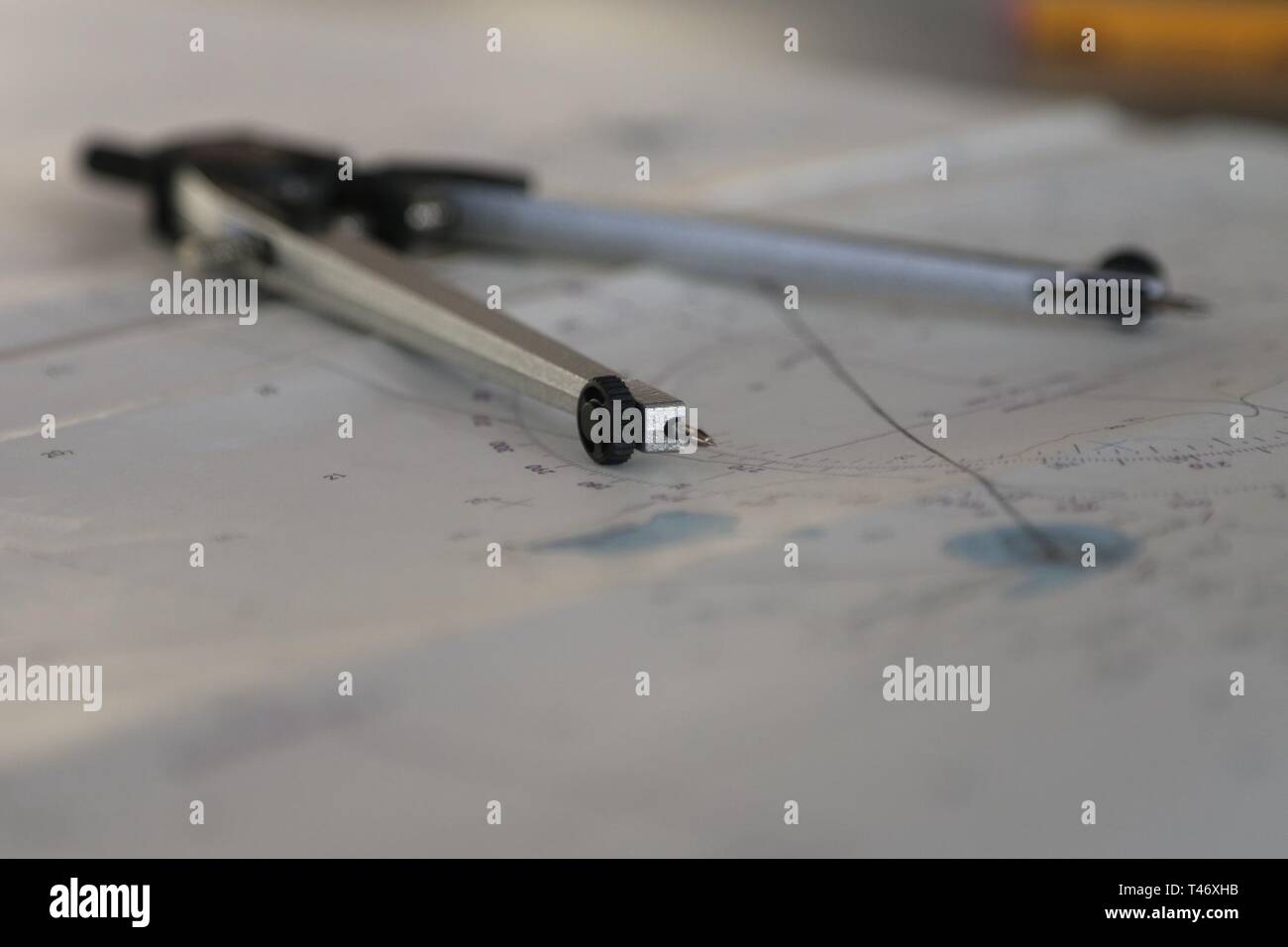 A drafting pen compass sits on a map abord the U.S. Army’s Logistics ...