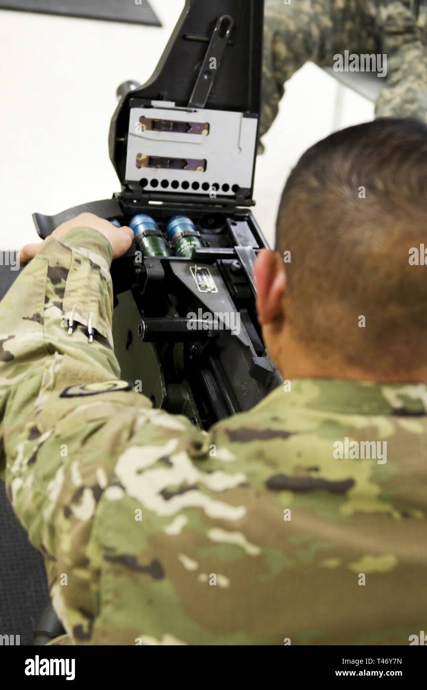 A U.S. Army Reserve Soldier loads dummy ammunition rounds into his M19 40 mm automatic grenade ...