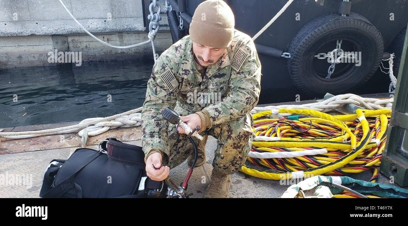 Builder 2nd Class Eli Arwood, assigned to Underwater Construction Team ...