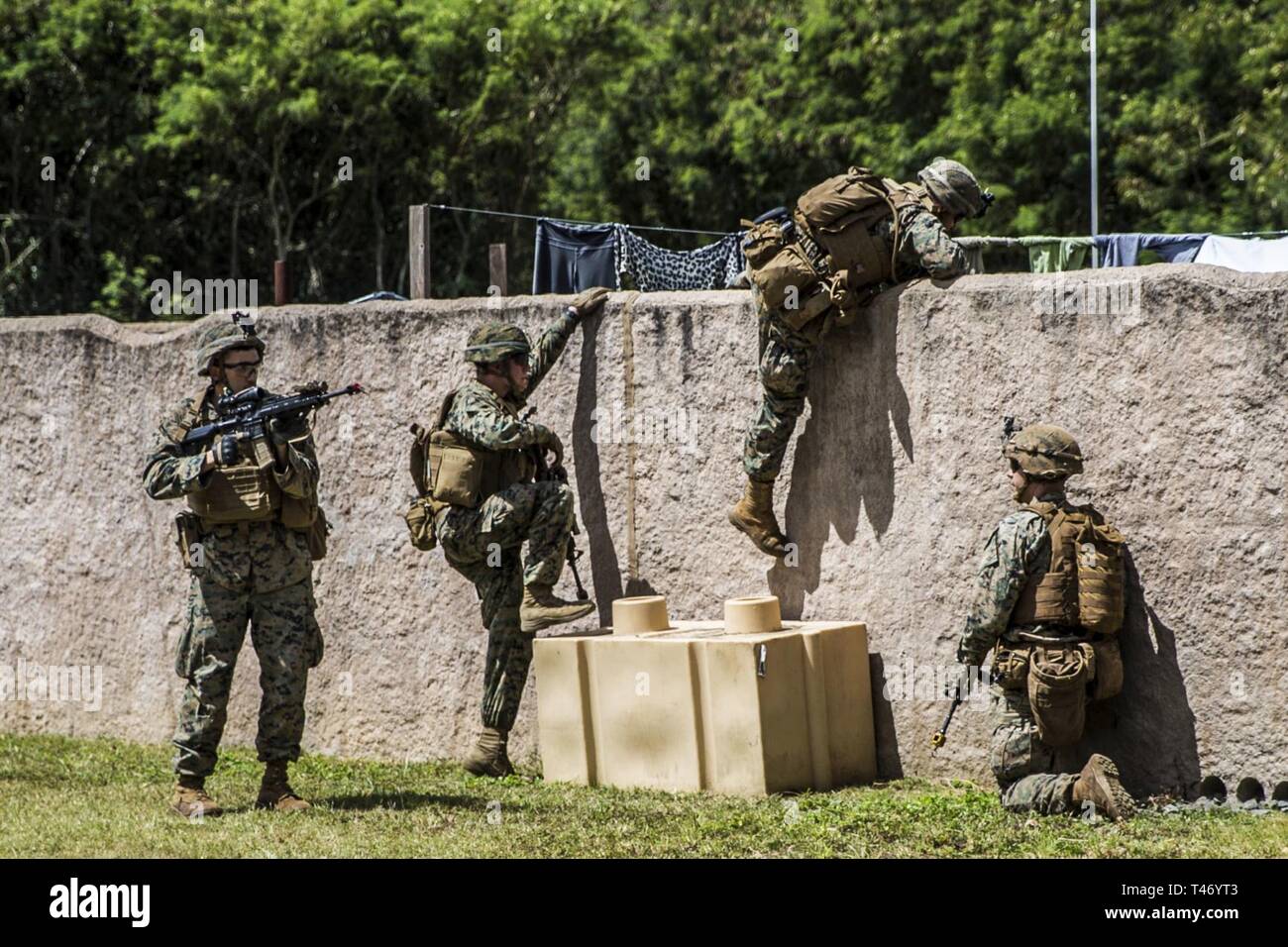 U.S. Marines with Golf Co., 2nd Battalion, 3rd Marine Regiment, scale a ...
