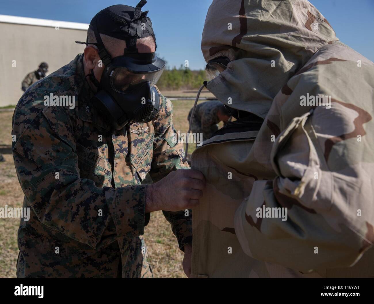 U.S. Marine Col. Frank Latt helps Lance Cpl. Jacob Daniels take off his ...