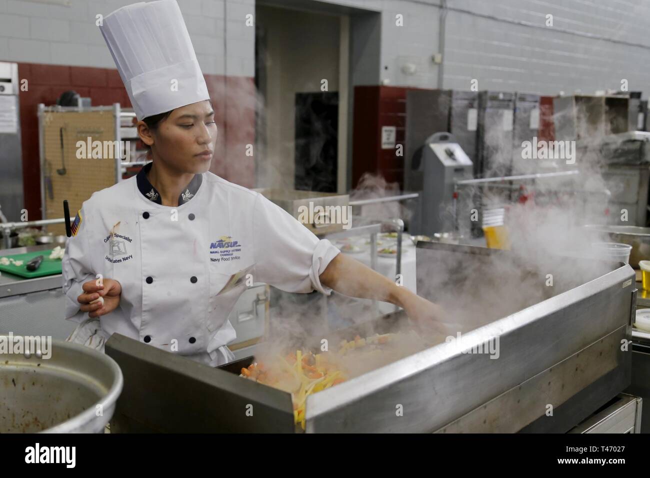 U.S. Navy Culinary Specialist 2nd Class Pan Phyu sautés vegetables ...