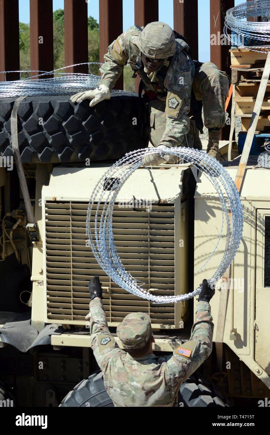 Soldiers with 610th Engineer Support Company prepare a roll of ...