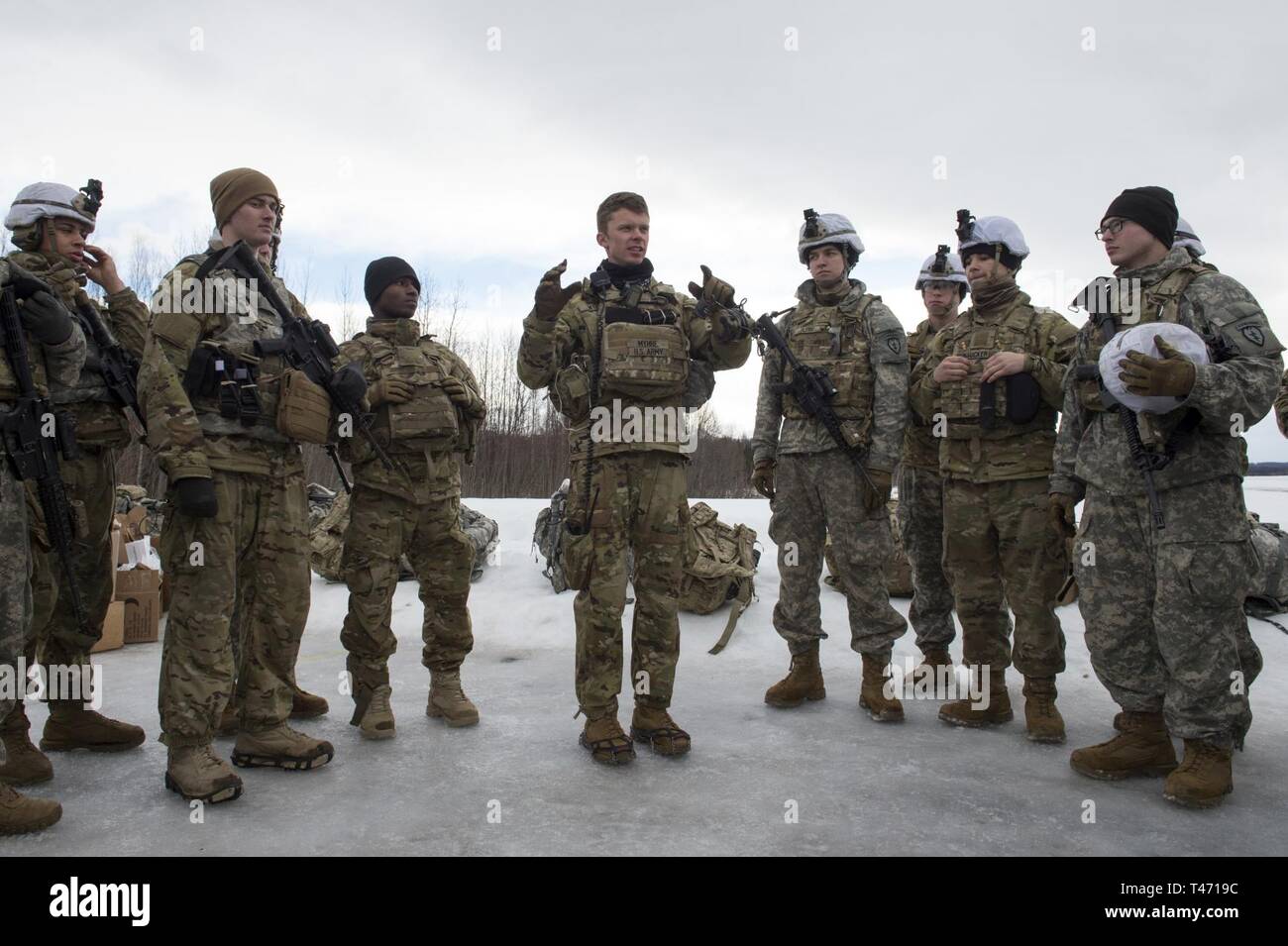 Army 1st Lt. Caleb Myhre, center, the range officer in charge assigned ...