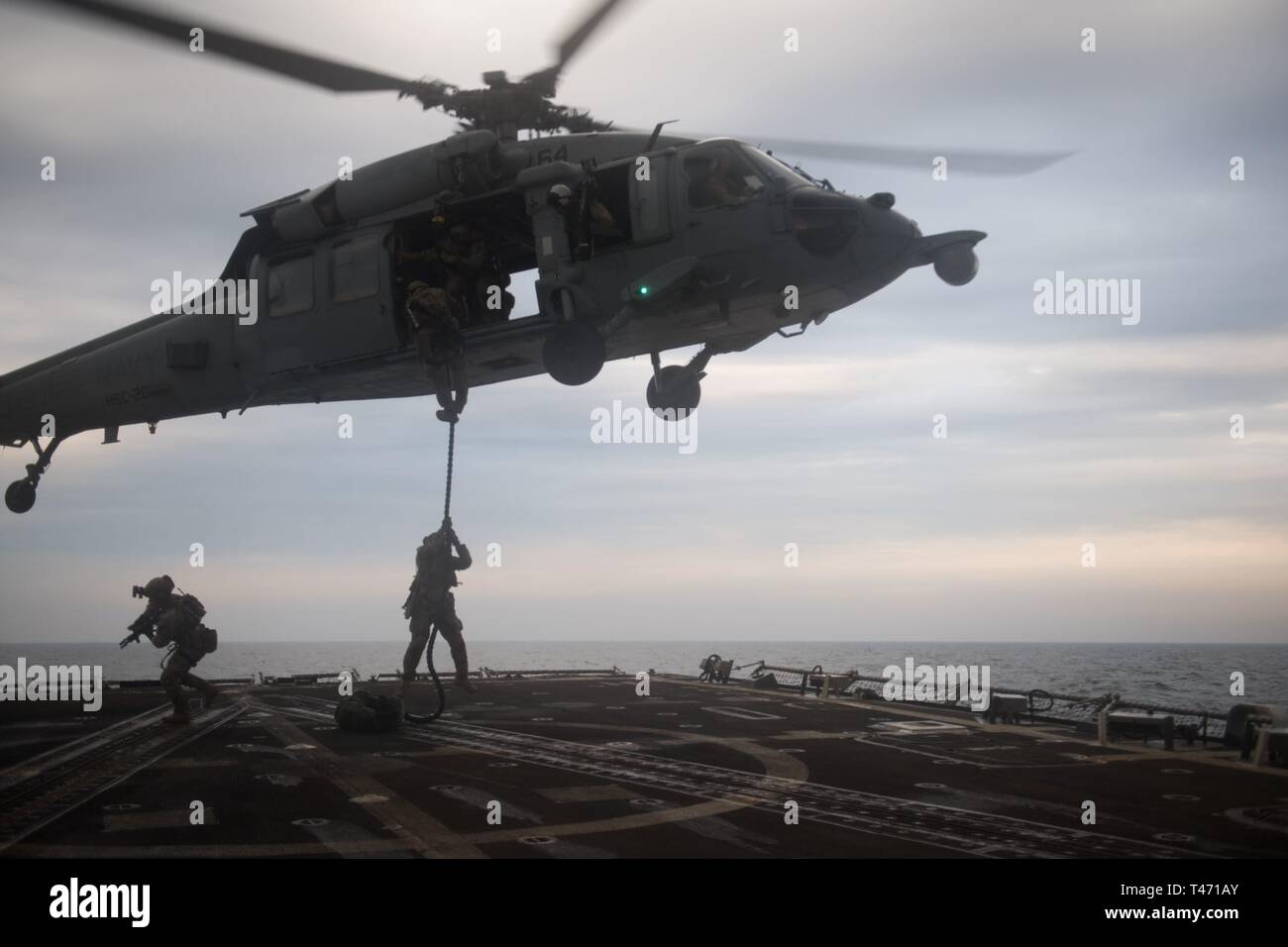 U.S. Coast Guard Maritime Security Reaction Team members rappel onto ...