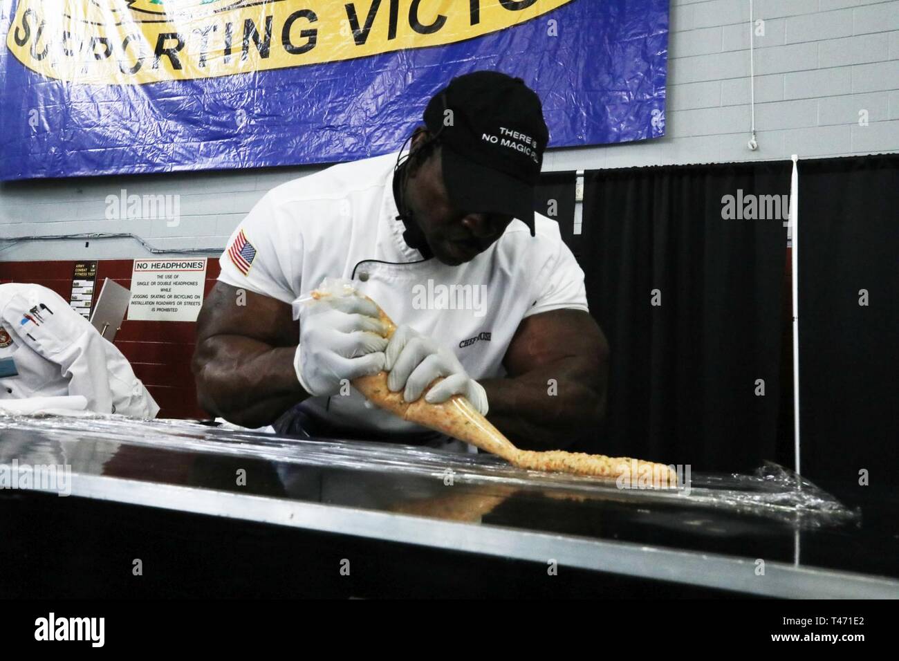 Retired Army Master Sgt. Andre Rush makes seafood sausage during a food ...