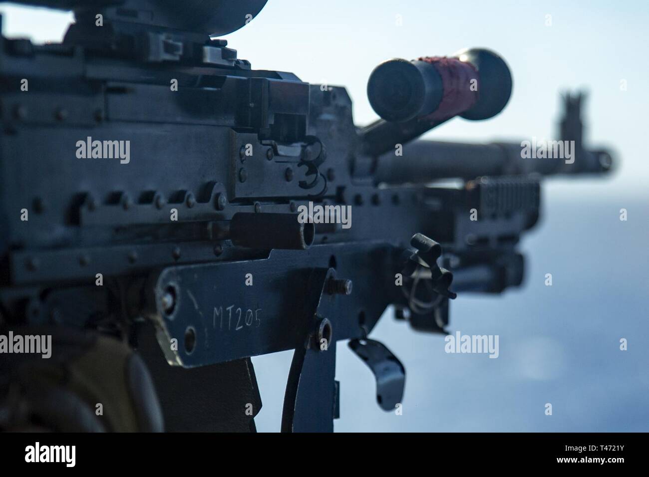 An M240B medium machine gun ejects links during operations aboard the ...