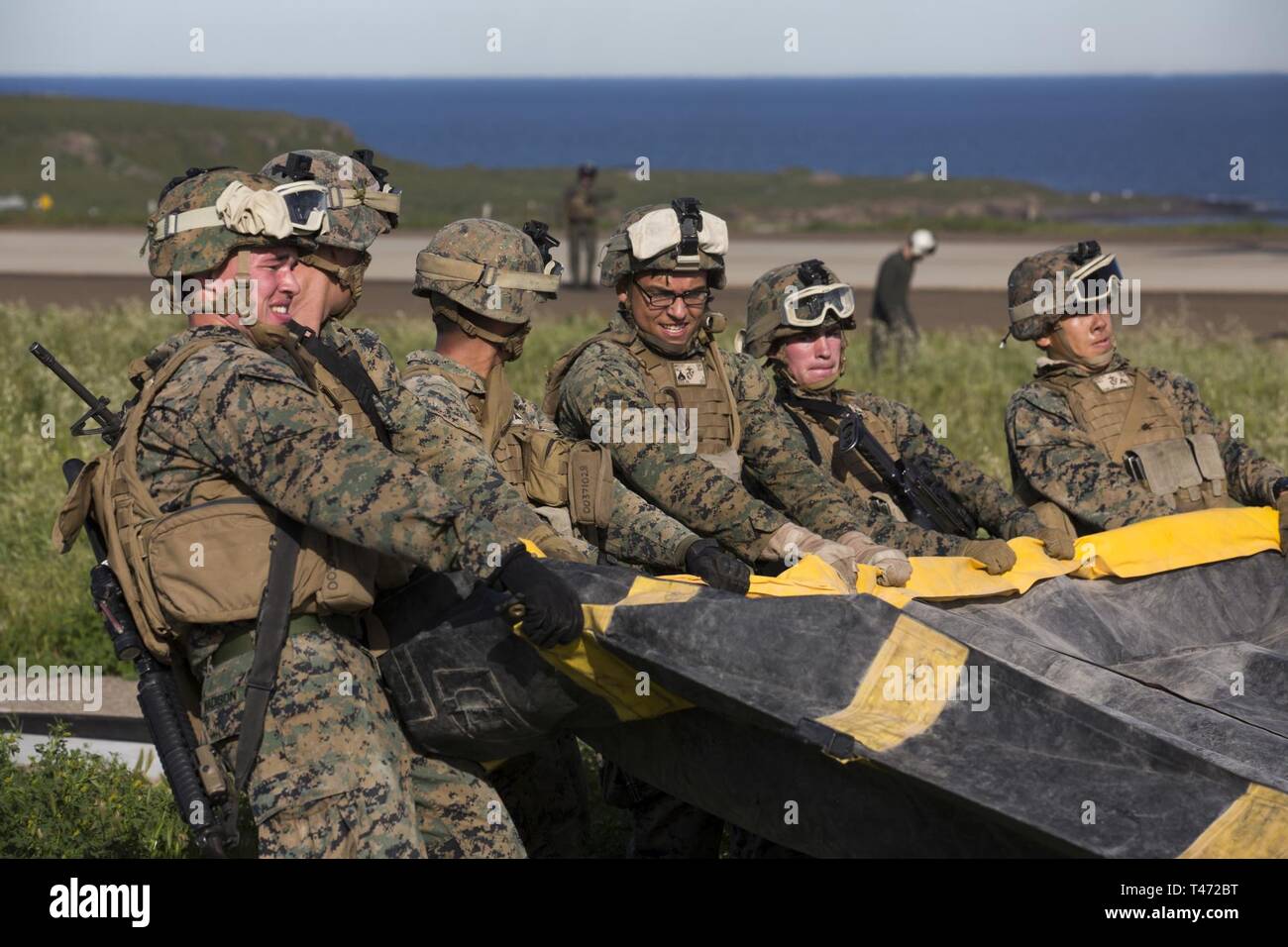 U.S. Marines with Marine Wing Support Squadron (MWSS) 371 pull a fuel ...