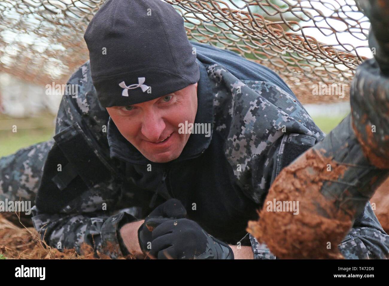 Bryan McNeeley conducts the low-crawl obstacle course March 15 during ...