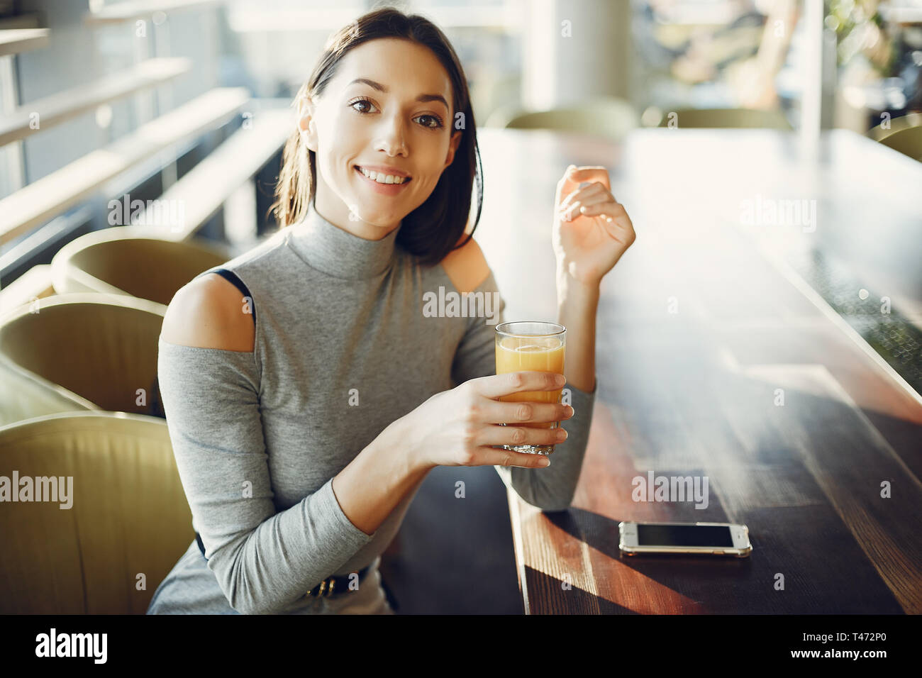 Beautiful girl in a cafe. Stylish girl sitting at the table. Lady in a ...