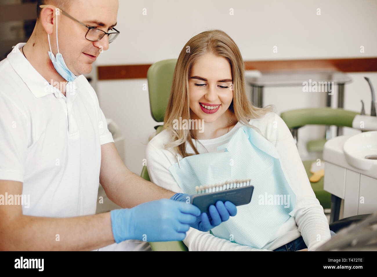 Beautiful girl sitting in the dentist's office Stock Photo - Alamy