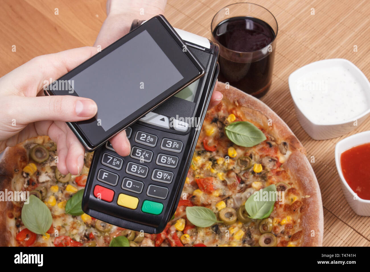 Using payment terminal and smartphone with NFC technology, cashless ...