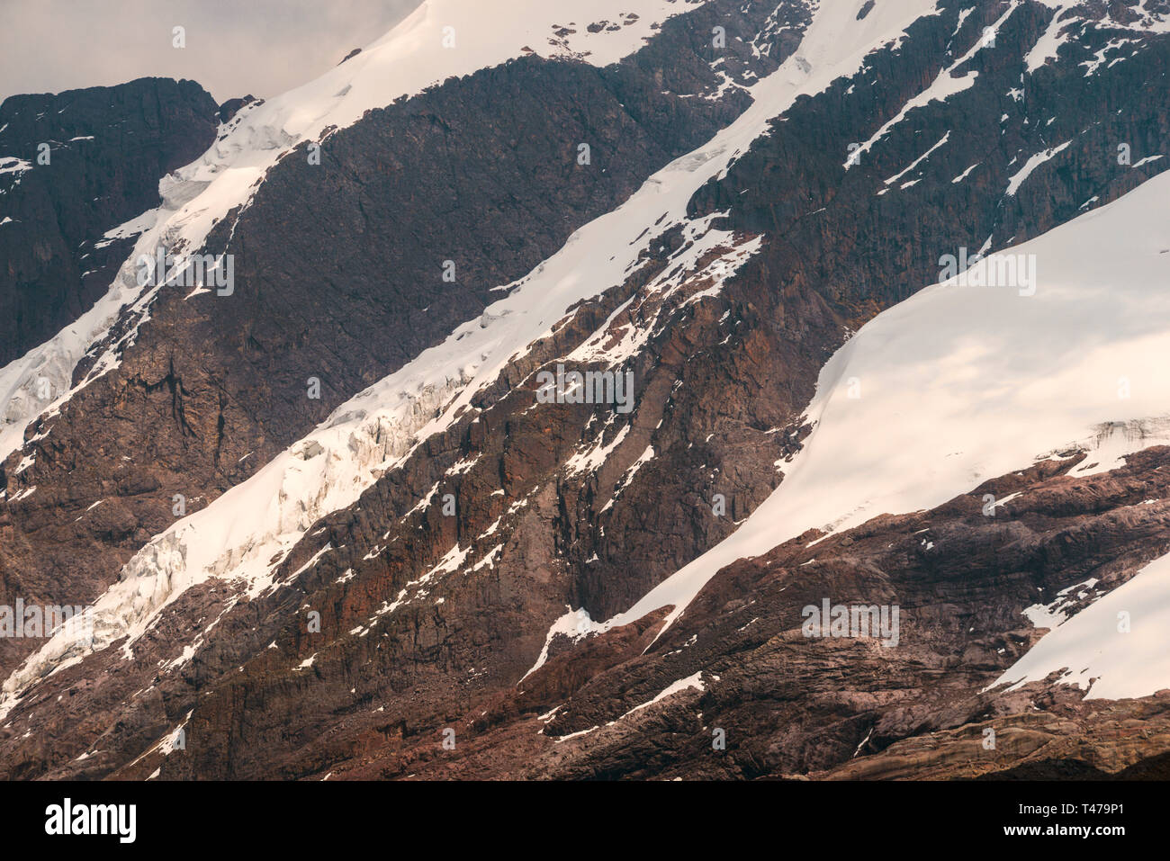 steep rocky mountain slope with snow remains in Peruvian Andes Stock ...