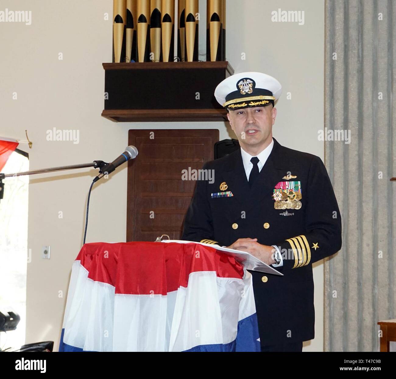 Capt. Robert Peters speaks to guests during a change of command ...
