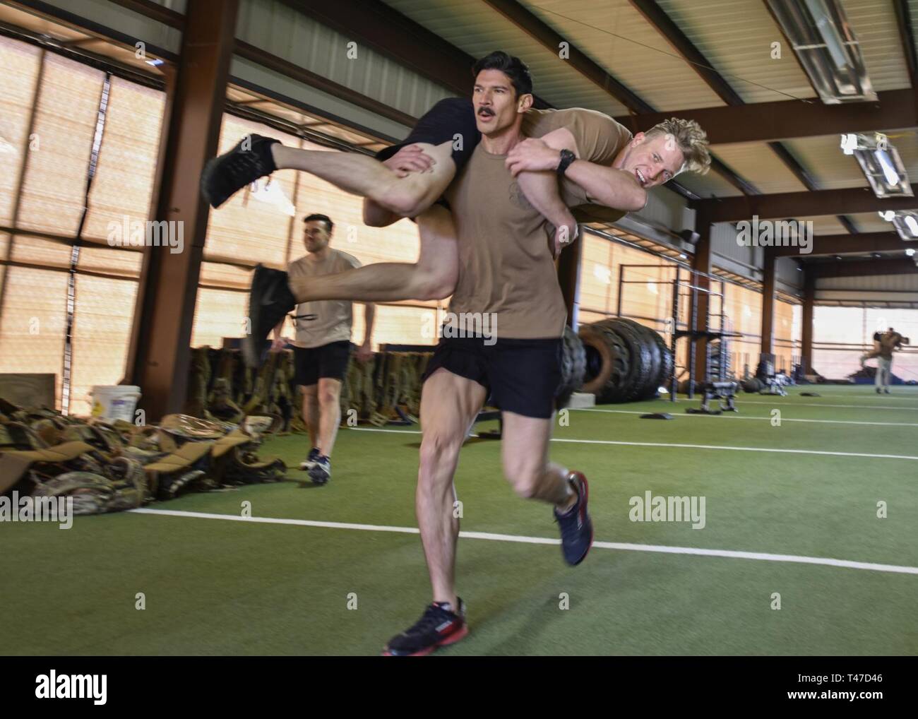 Participants in the Maltz Challenge perform the 100-yard fireman’s ...
