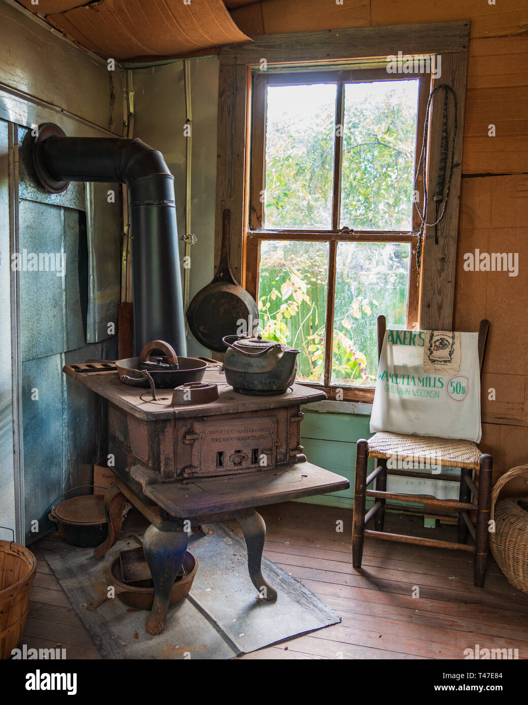 Vintage Kitchen with Antique Stove by Window Stock Photo - Alamy