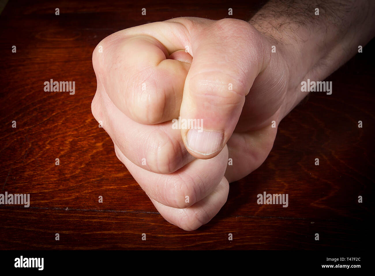 Male fist on table hi-res stock photography and images - Alamy