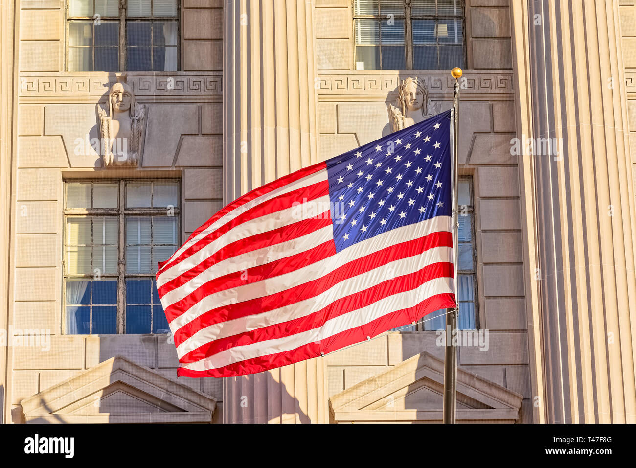USA flag on facade of US Commerce building in Washington DC Stock Photo ...