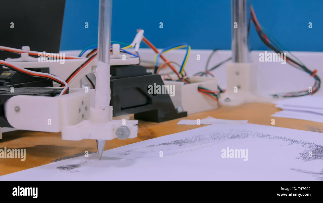 Robotic arm with black pen drawing portrait Stock Photo - Alamy