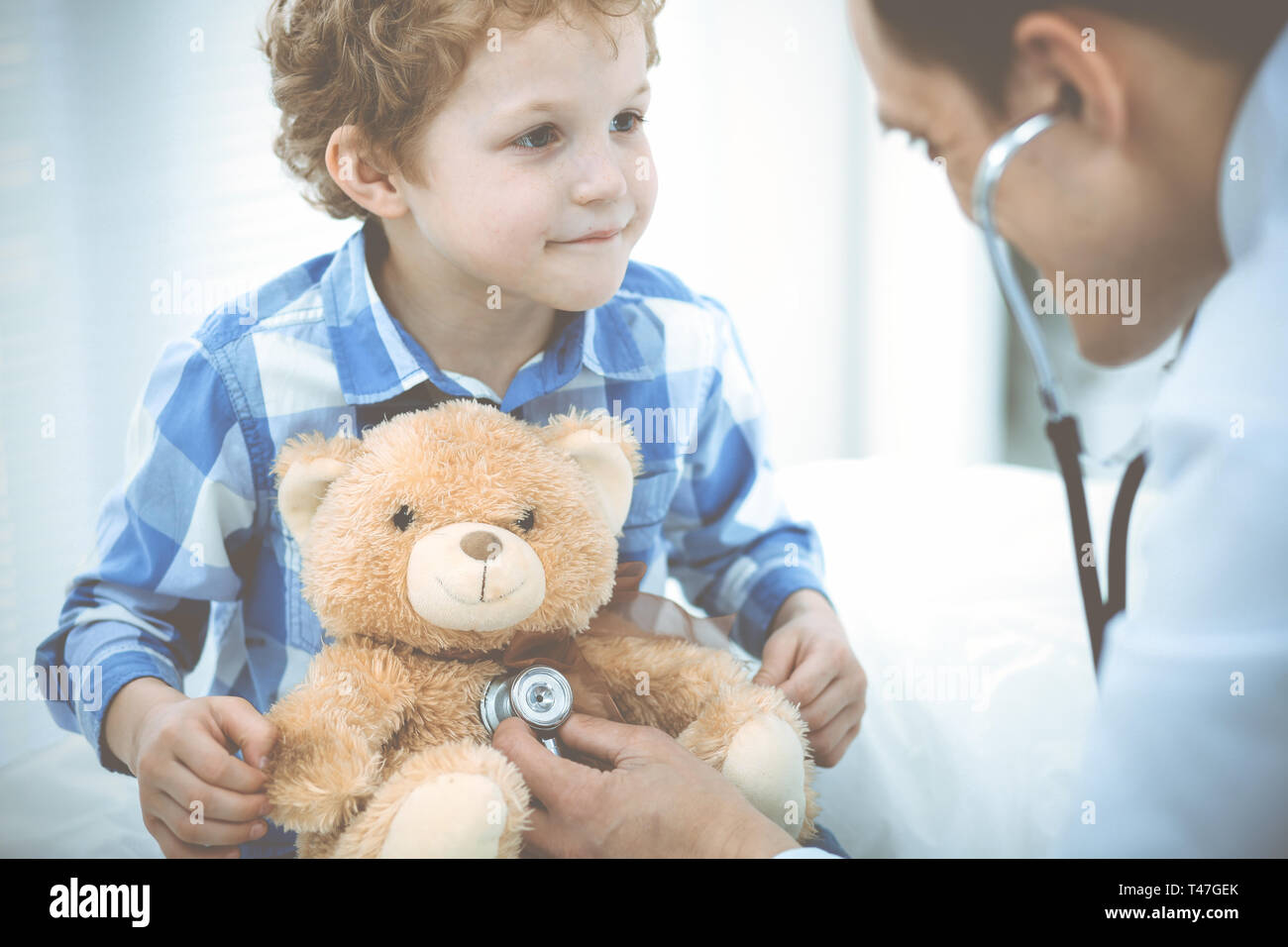 Doctor and patient child. Physician examining little boy. Regular ...