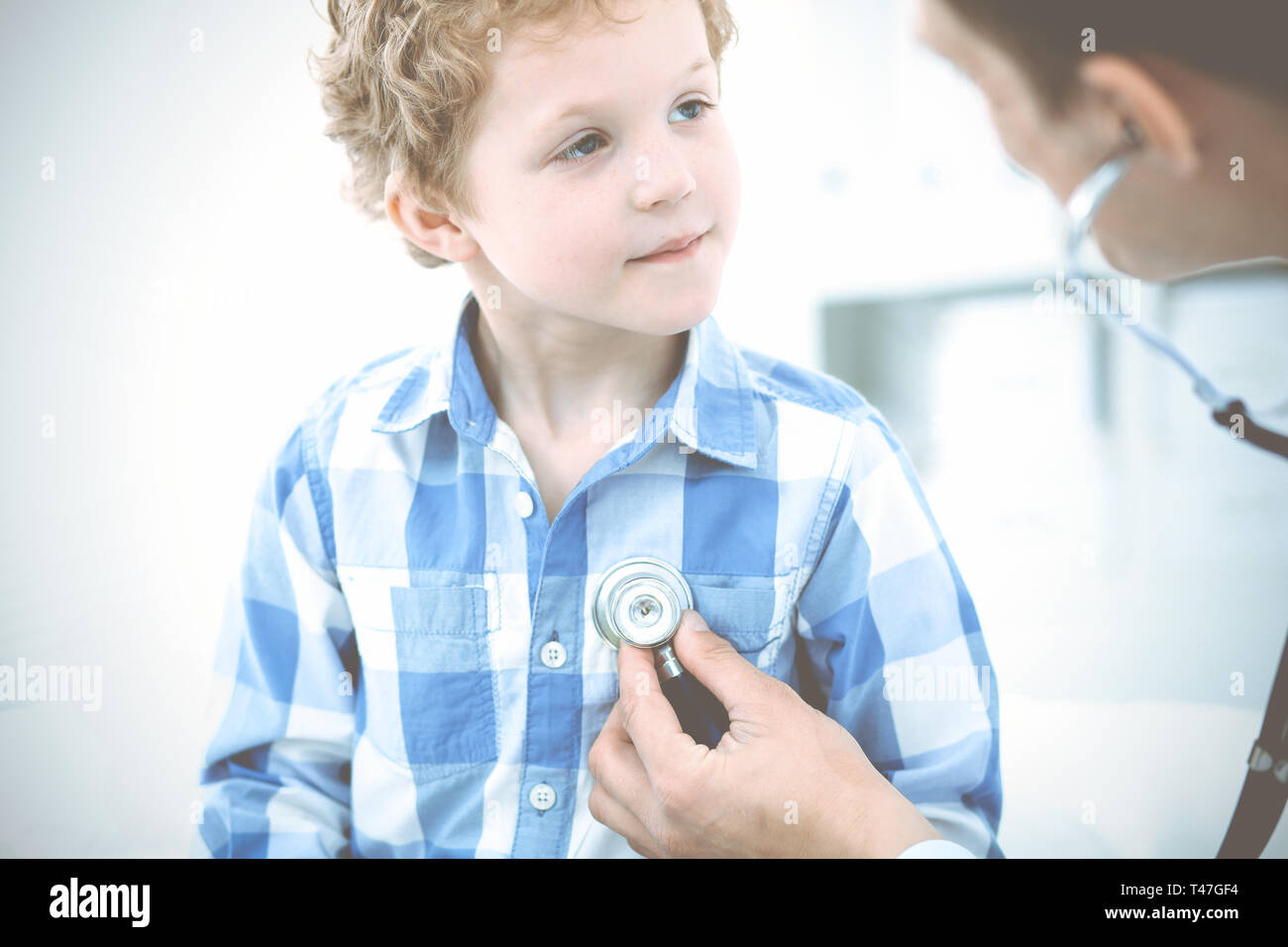 Doctor and patient child. Physician examining little boy. Regular ...