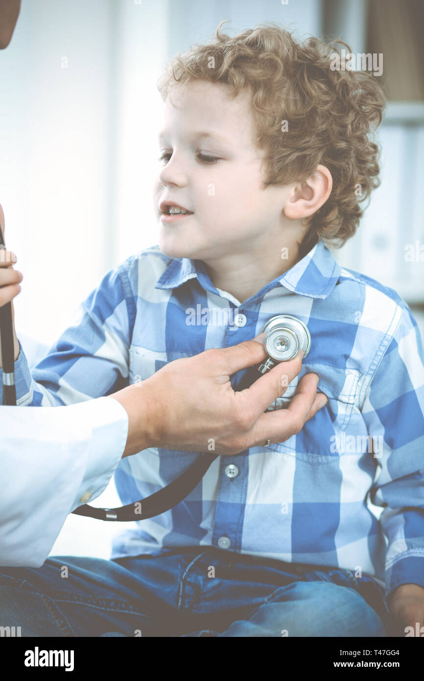 Doctor and patient child. Physician examining little boy. Regular ...