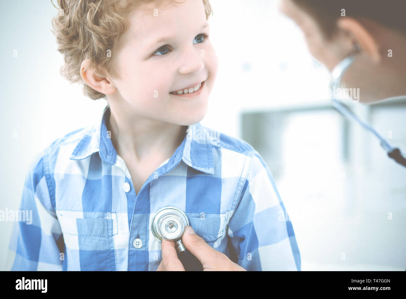 Doctor and patient child. Physician examining little boy. Regular ...
