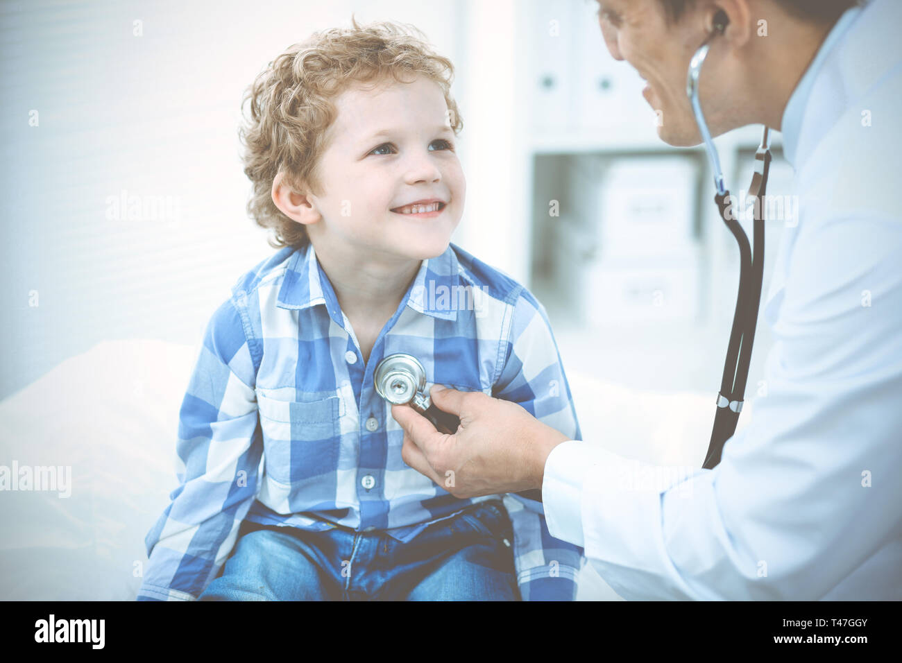 Doctor and patient child. Physician examining little boy. Regular ...