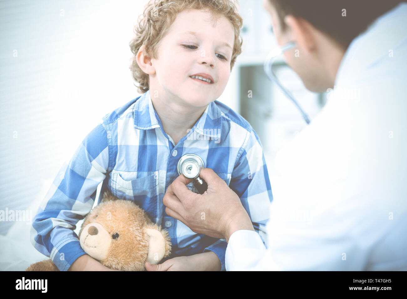 Doctor and patient child. Physician examining little boy. Regular ...