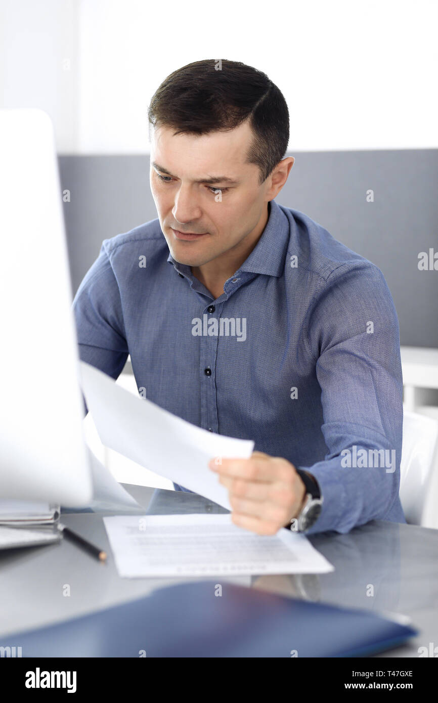 Businessman working with computer in modern office. Headshot of male ...