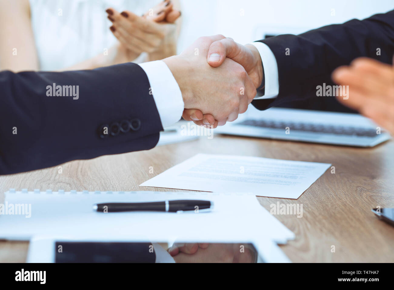 Business people shaking hands at meeting or negotiation in the office ...