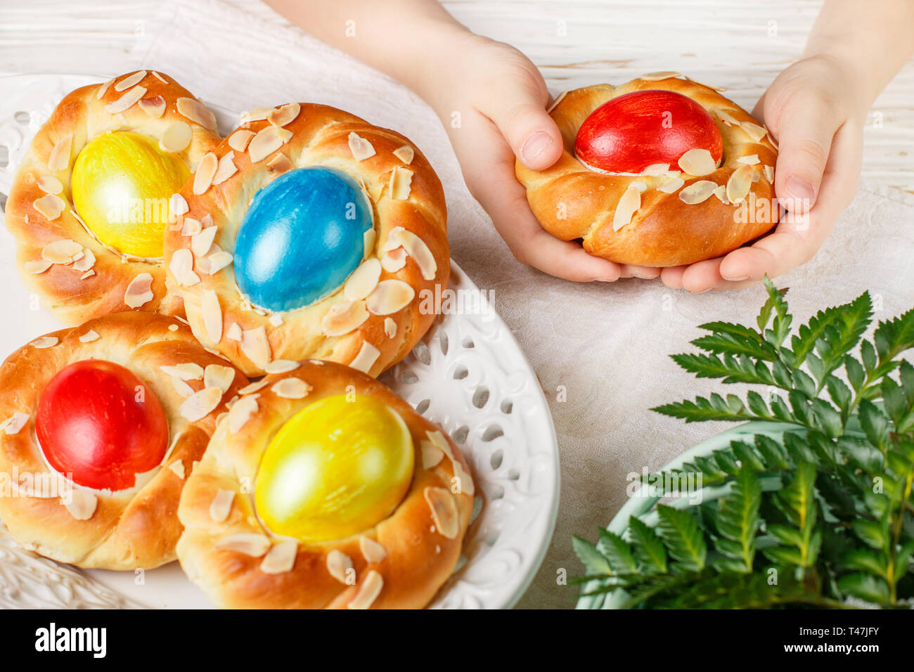 Traditional Easter buns decorated with eggs, almond petals and lemon ...