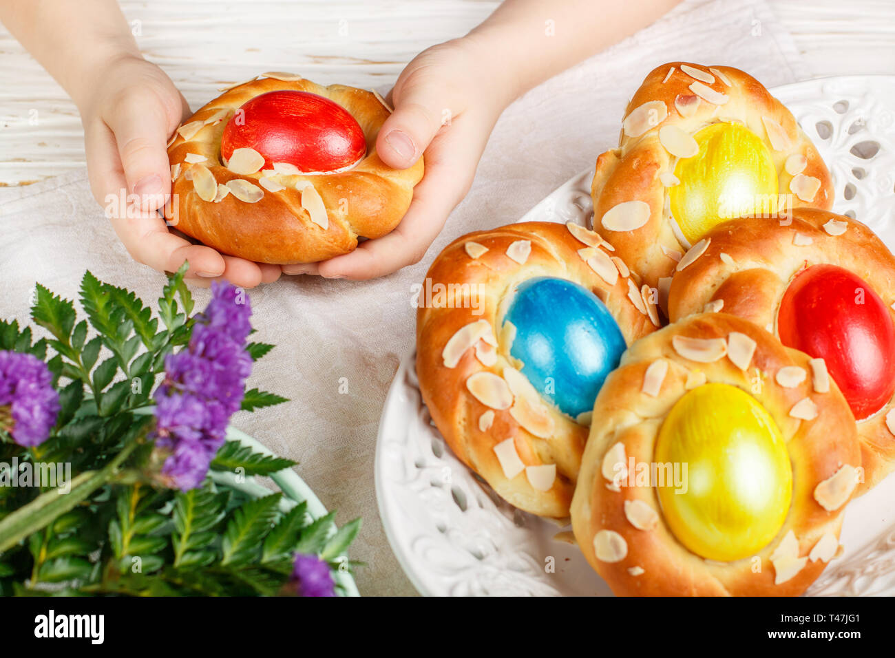 Traditional Easter buns decorated with eggs, almond petals and lemon ...