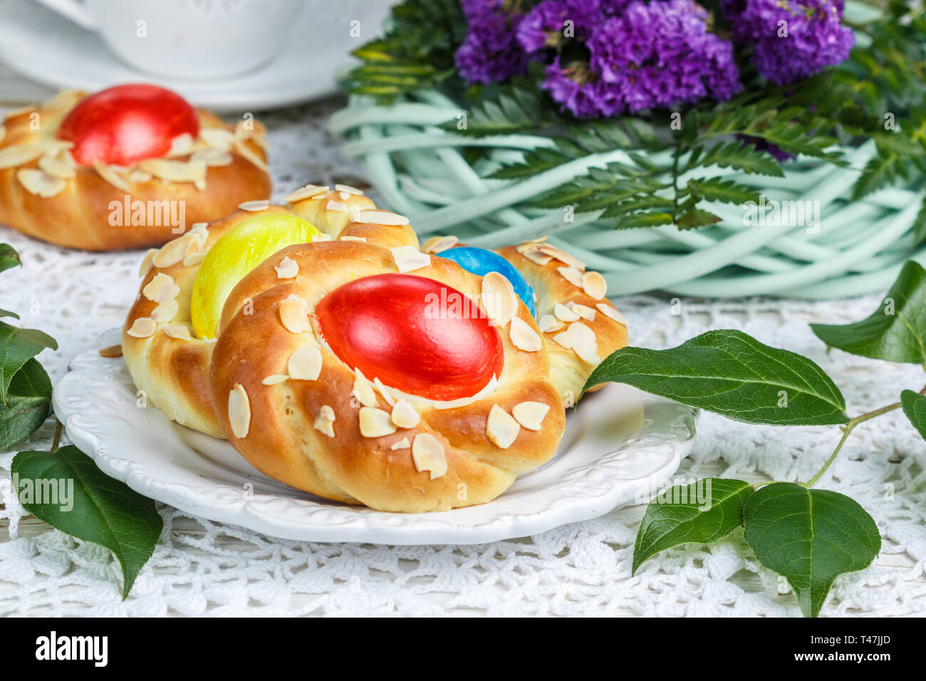 Traditional Easter buns decorated with eggs, almond petals and lemon ...