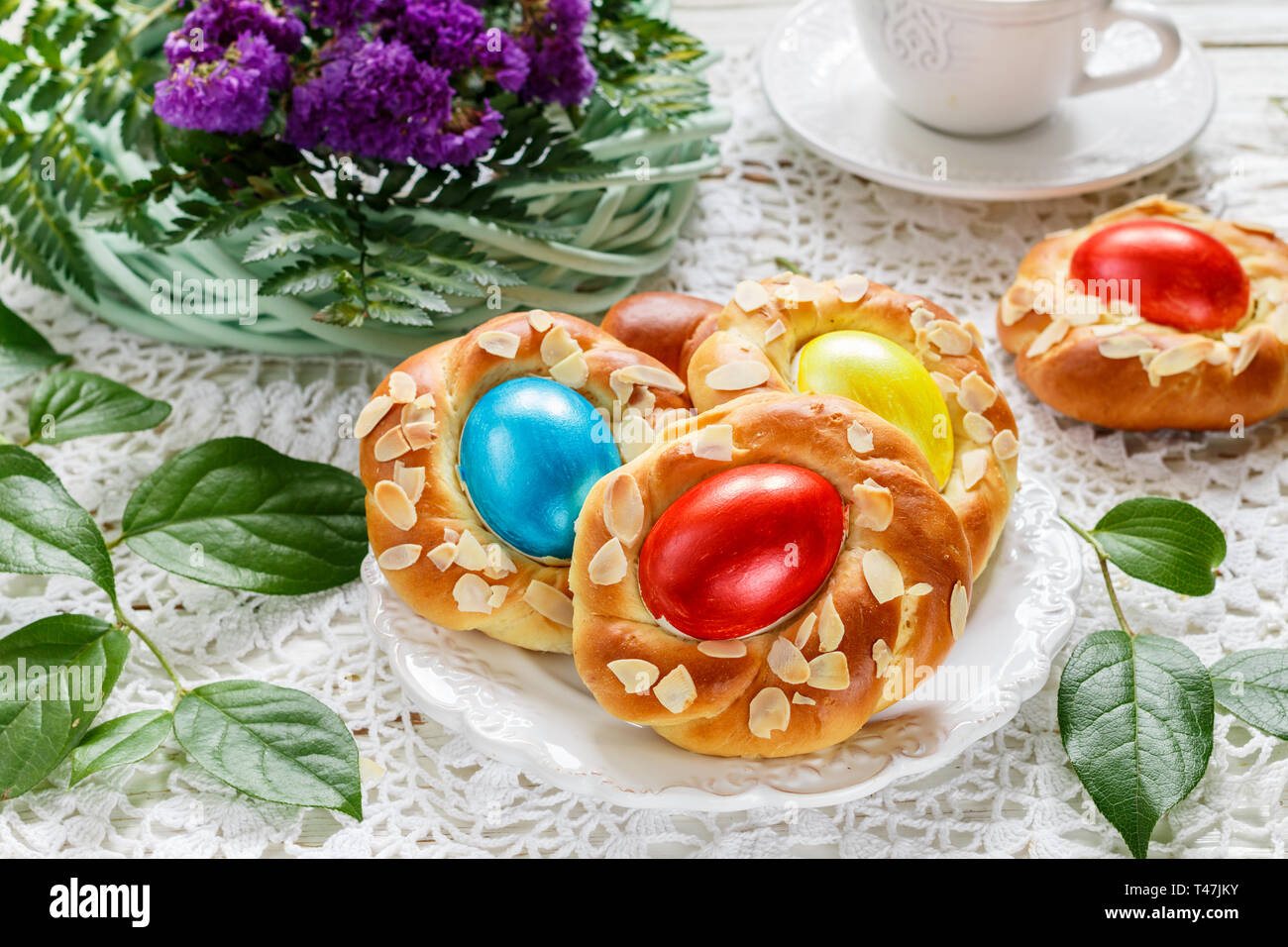 Traditional Easter buns decorated with eggs, almond petals and lemon ...