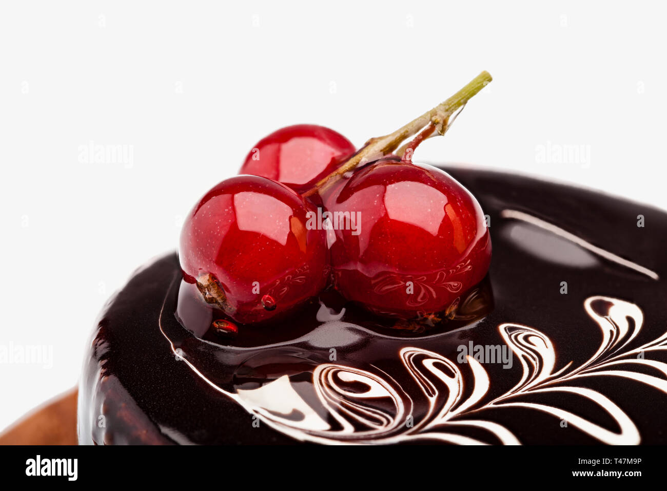 Chocolate dessert with three cherries close-up with a pattern on a ...